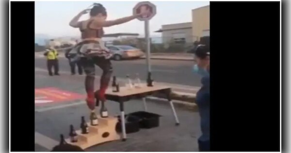 viral video of woman doing stunt on glass bottles balancing act amazing ...