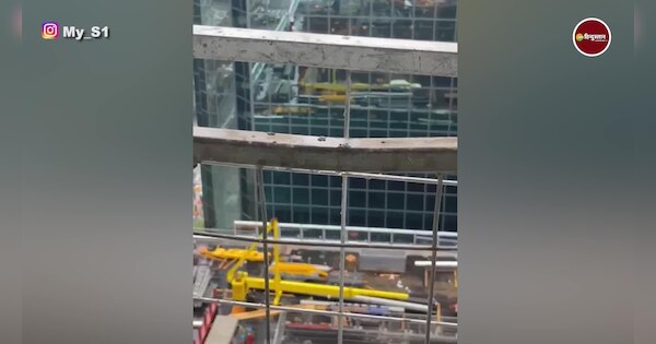 Video of a worker dangling in mid air from a crane at a construction ...