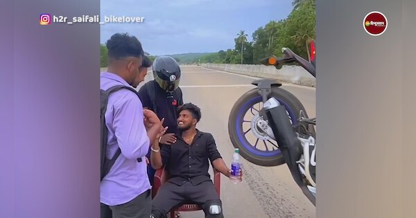 man doing bunk stunt opens the cap of the bottle by doing stunt with ...
