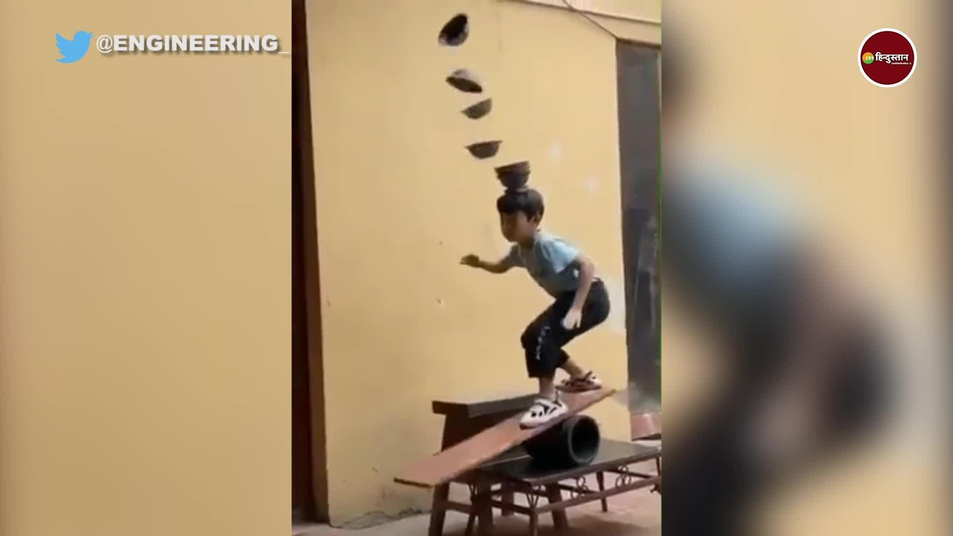 trending weird viral video of a boy balancing trick with stacking bowls ...