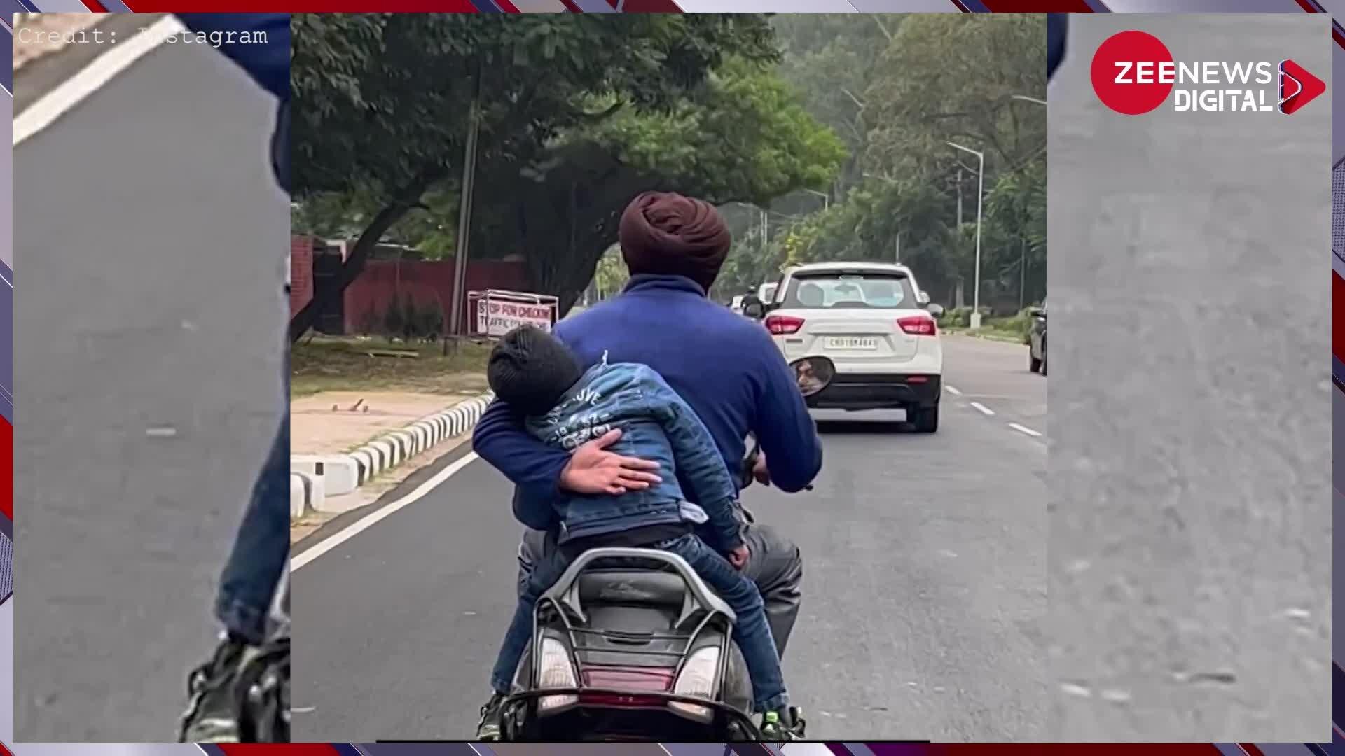 punjab man prevents sleeping son from falling off scooter videos goes ...