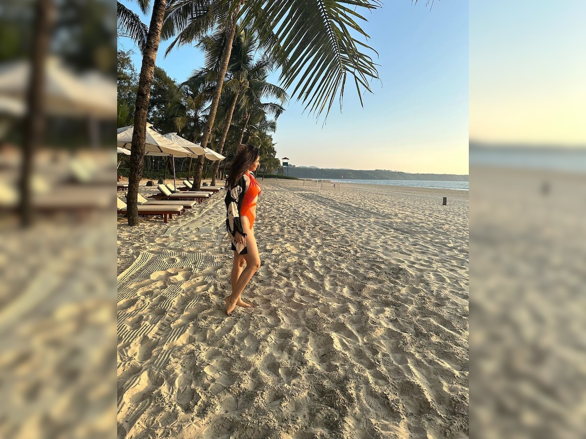 Neha sharma flaunts sexy figure in orange bikini at sea shore, actress ...