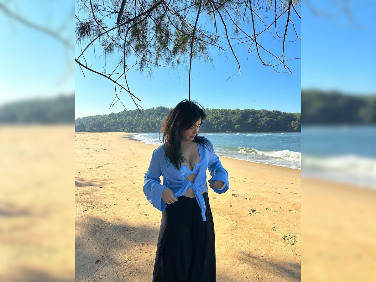 Neha sharma flaunts sexy figure in orange bikini at sea shore, actress ...