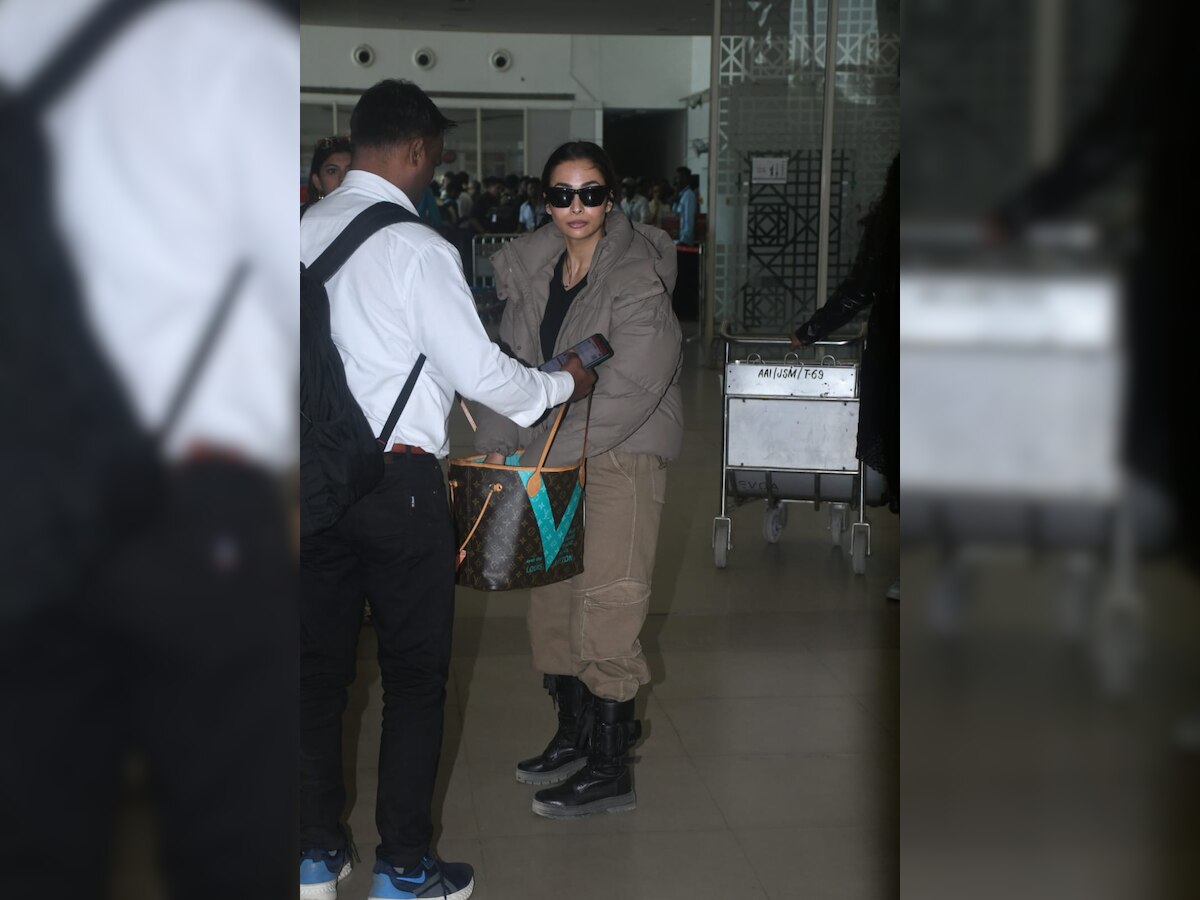 Sexy Malaika Arora spotted in Jaisalmer airport wear black cop top with ...