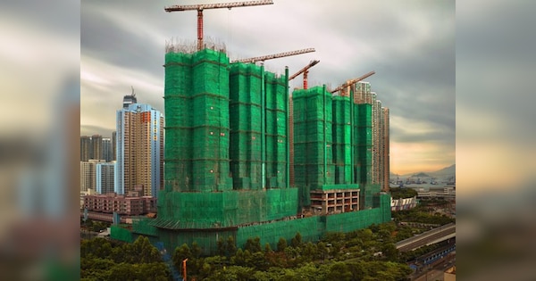 why are buildings in construction sites covered with green coloured ...