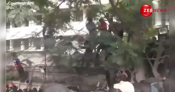 RCB fans climb over the M Chinnaswamy Stadium walls fences to get ...
