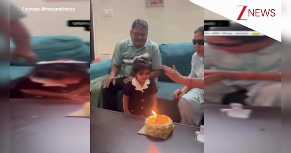 girl folded hand seeing candle while her grandparents cutting cake sankar umar se bade hain iske ...
